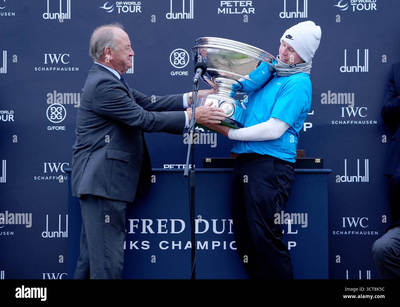 Peter Dawson presents the trophy to Robert McIntyre after he wins the ...