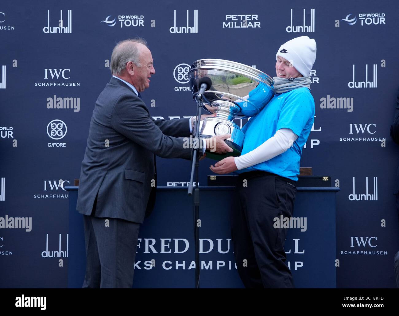 Peter Dawson presents the trophy to Robert McIntyre after he wins the ...