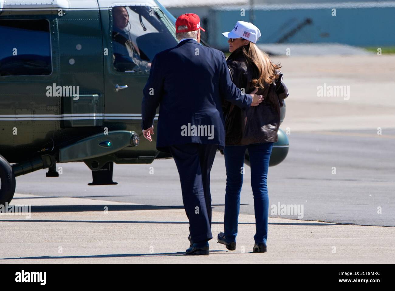 President Donald Trump and first lady Melania Trump walk to board ...