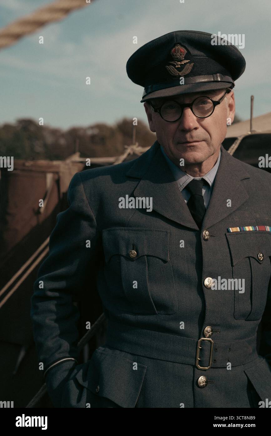RAF officer in vintage uniform at historic airfield with classic ...