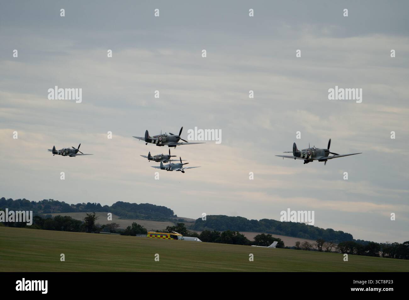 Formation of Supermarine Spitfires flying over Duxford airfield in ...