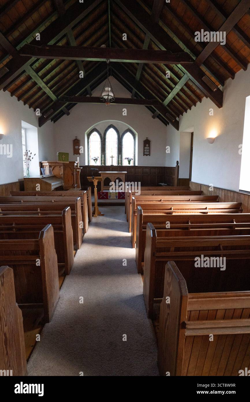Interior of traditional church with wooden pews and exposed beam ...