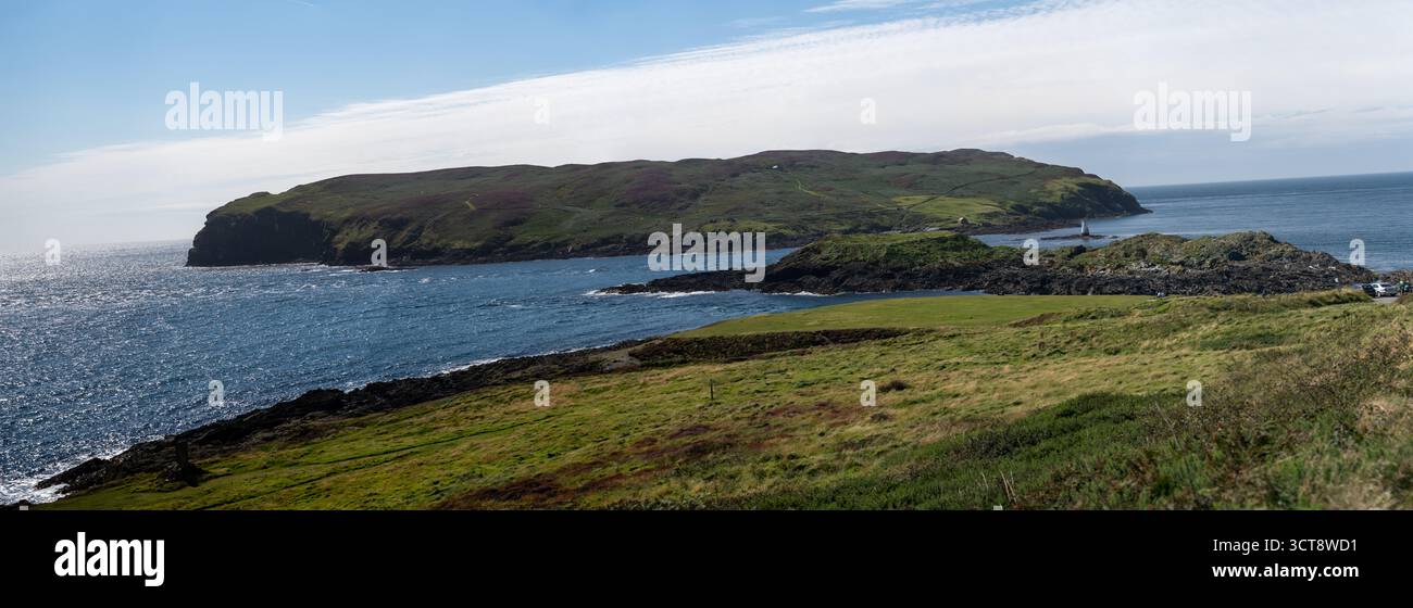 Panoramic view of rugged coastal headland and green fields overlooking ...