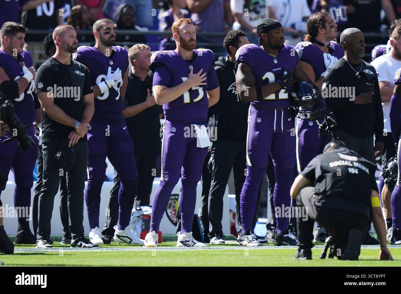 Baltimore Ravens quarterback Cooper Rush (15) and other players stand ...