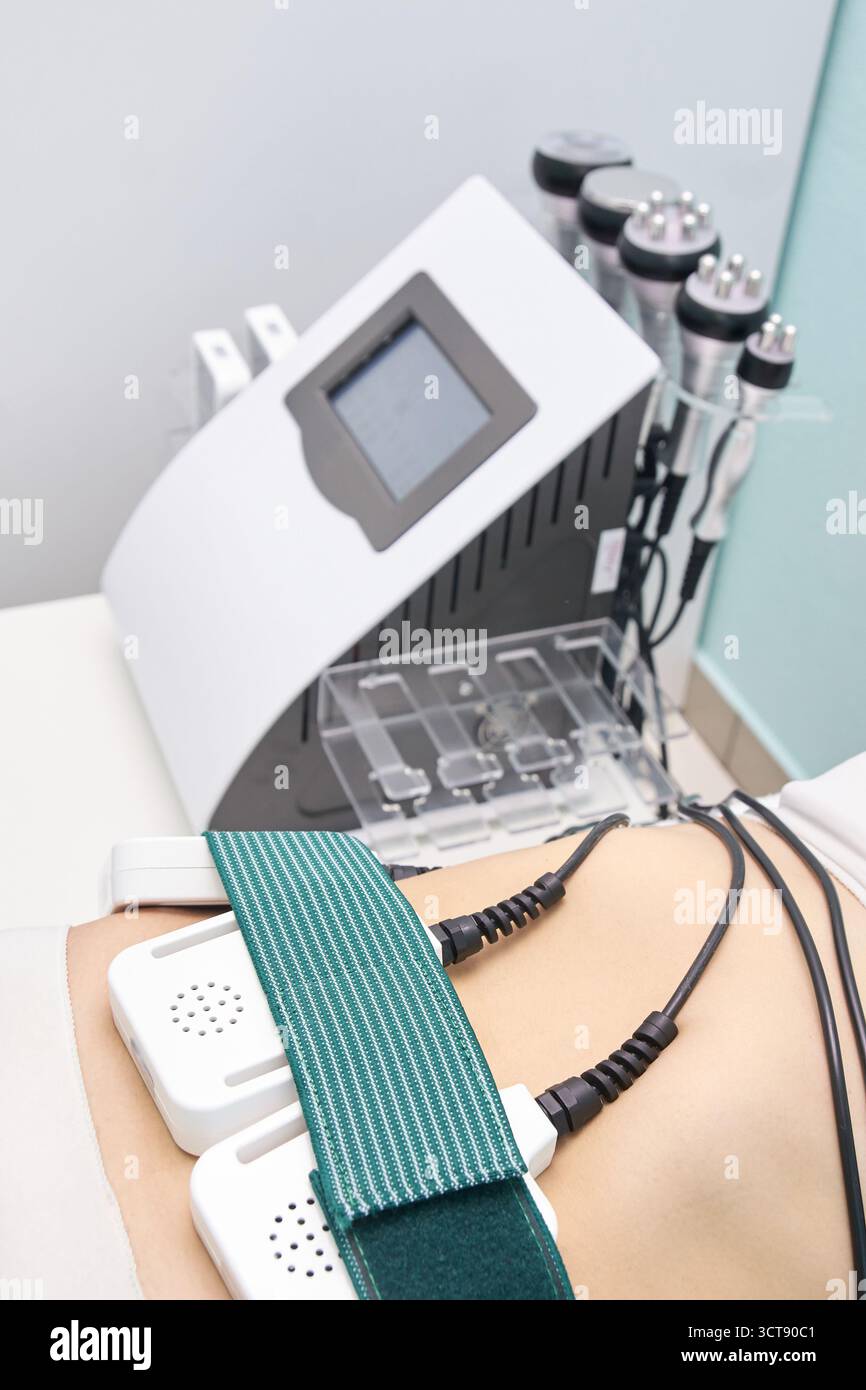 Female undergoing non-invasive body contouring treatment with advanced ...
