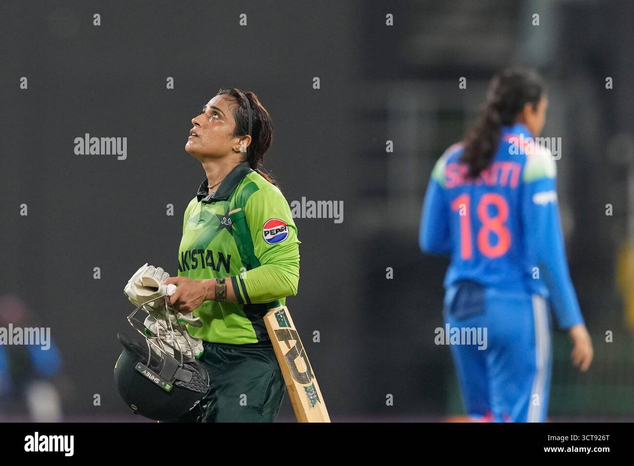 Pakistan's Sidra Amin leaves the ground after losing her wicket during ...