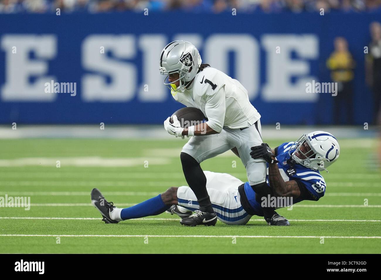 Las Vegas Raiders wide receiver Tre Tucker is tackled by Indianapolis ...