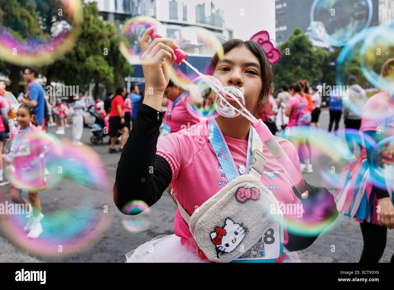 A fan of Japanese character Hello Kitty blows bubbles during a Hello ...