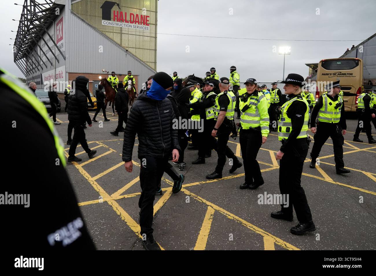 Police officers move Rangers fans back as the Rangers team bus leaves ...