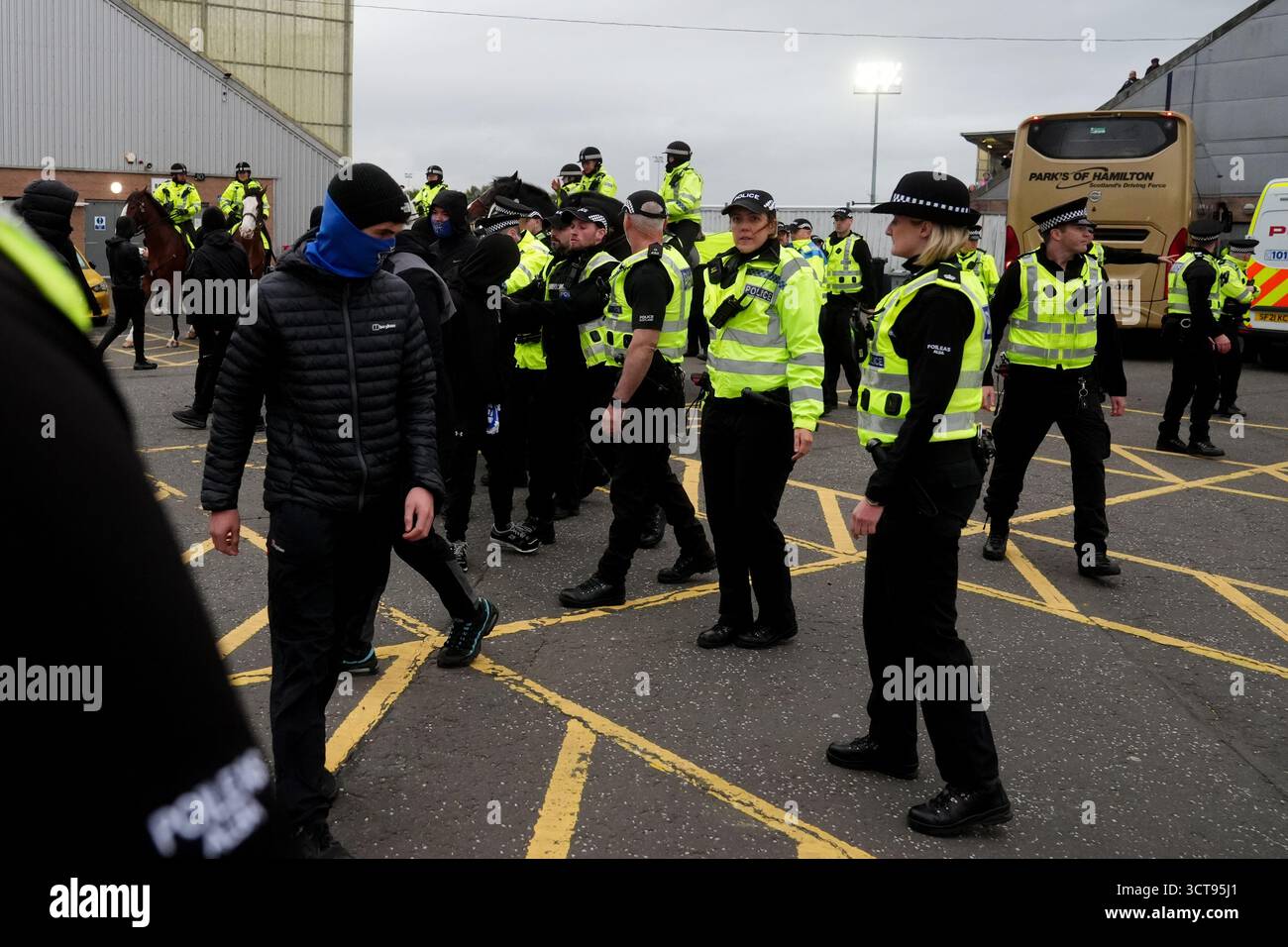 Police officers move Rangers fans back as the Rangers team bus leaves ...