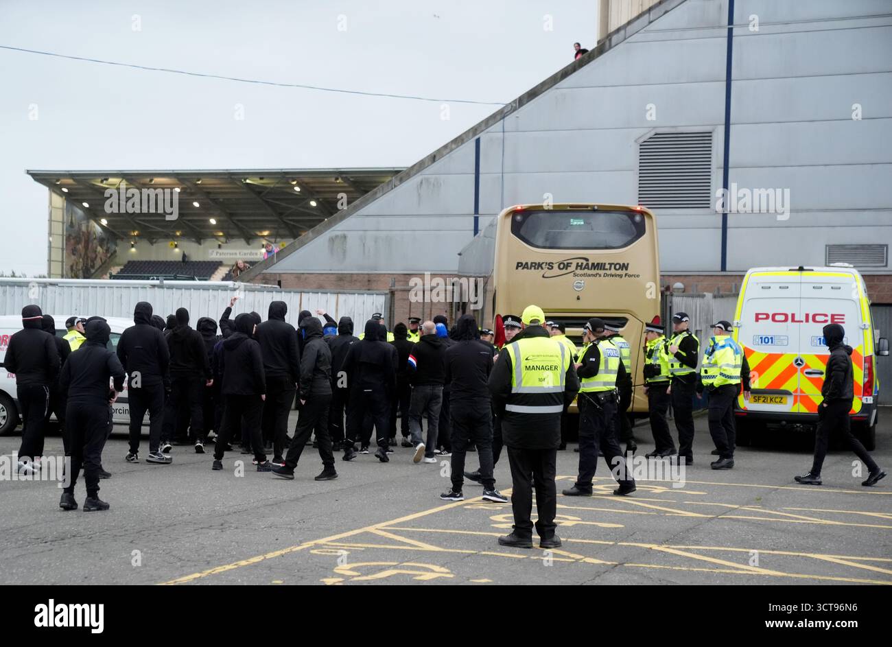 Police officers look on as Rangers fans try to stop the Rangers team ...