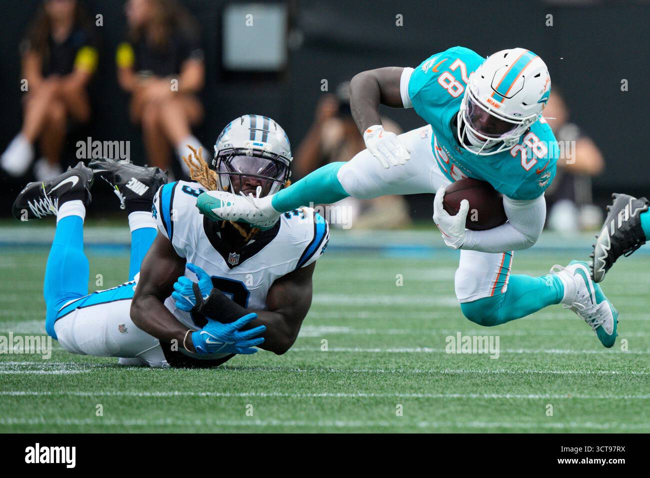 Miami Dolphins running back De'Von Achane is tackled by Carolina ...