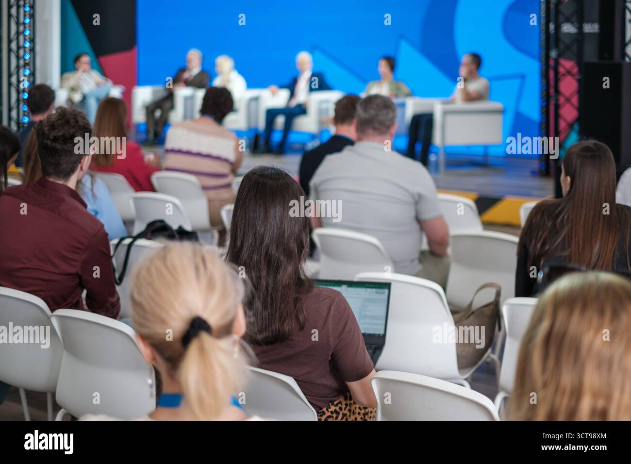 Panel discussion at modern conference featuring diverse speakers ...