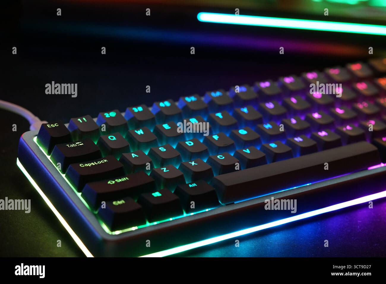 Colorful gaming keyboard with RGB lighting in a dark room during a ...