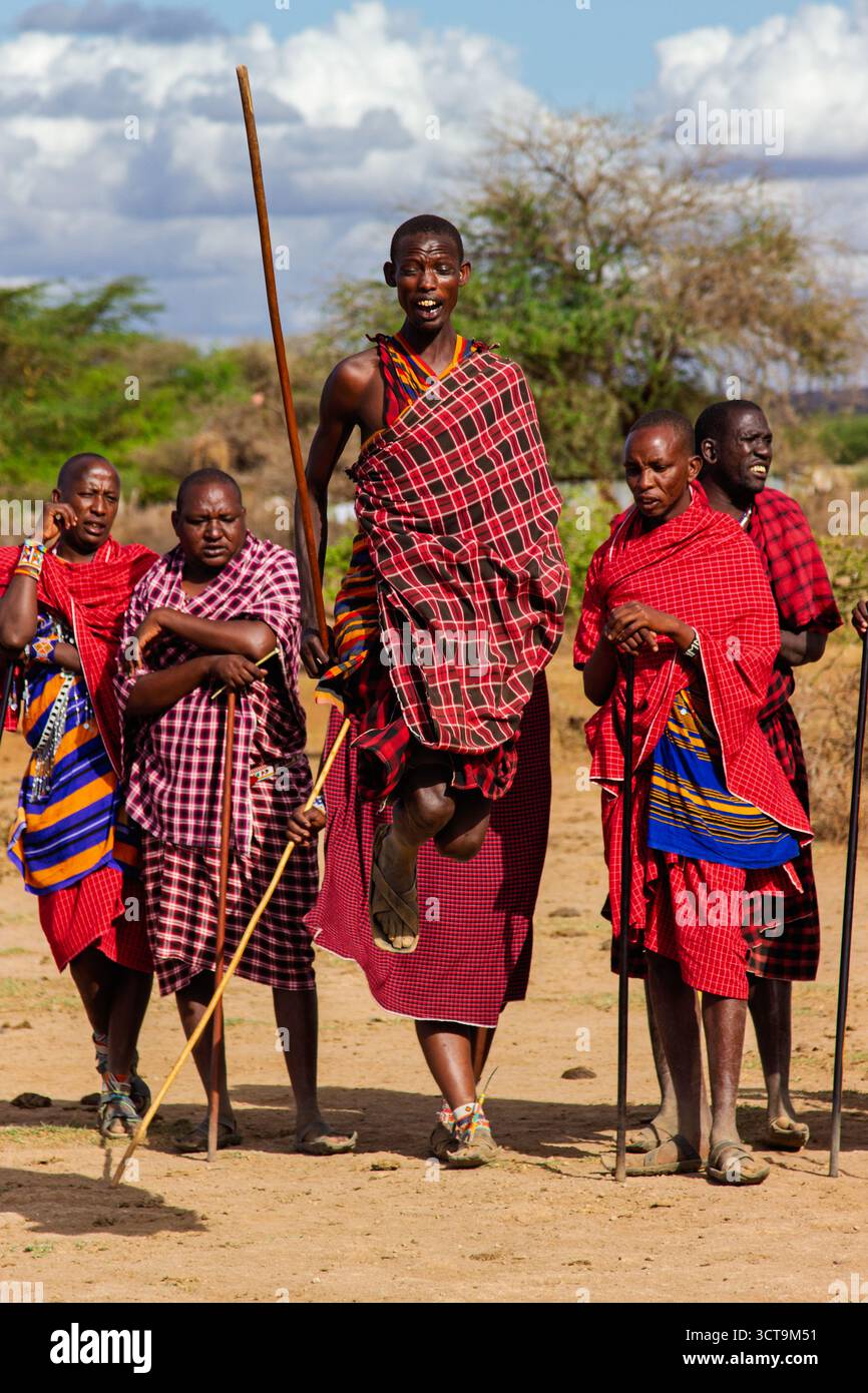 Maasai men in Kenya perform a traditional jumping dance, a display of ...