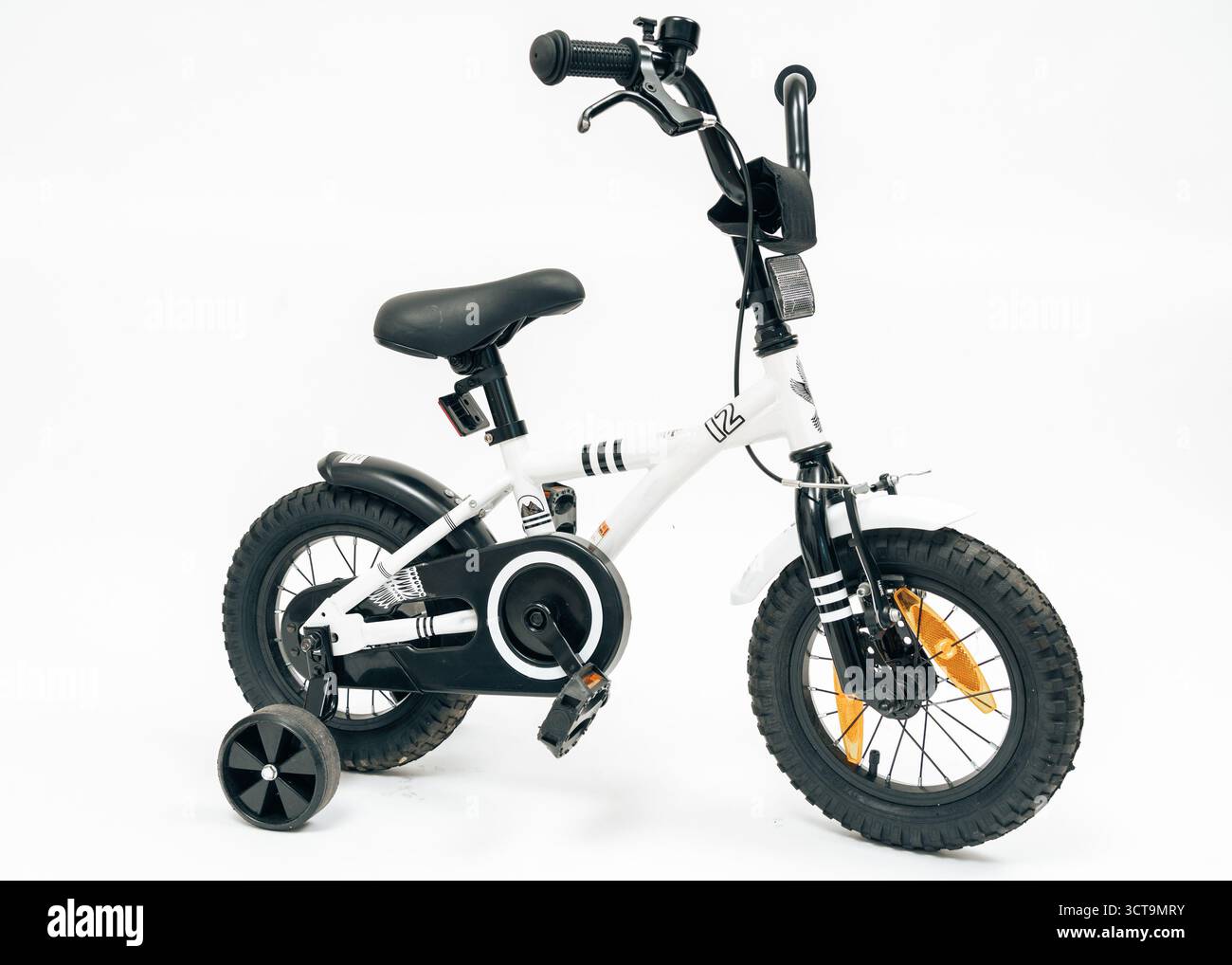 Modern white kids bike with training wheels, photographed for catalog ...