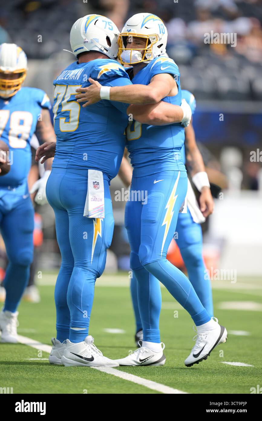 Los Angeles Chargers quarterback Justin Herbert (10) hugs center ...