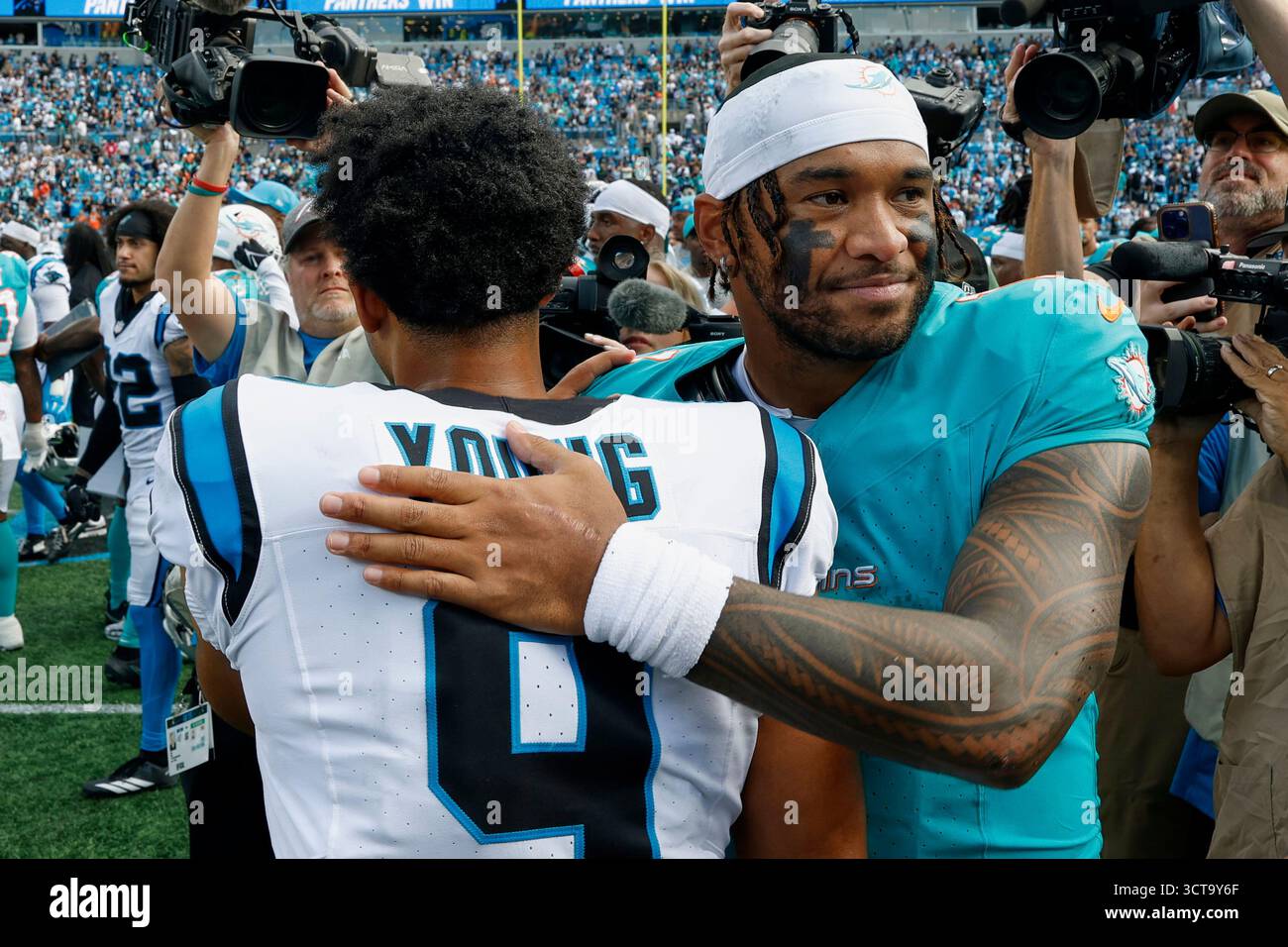 Miami Dolphins quarterback Tua Tagovailoa hugs Carolina Panthers ...