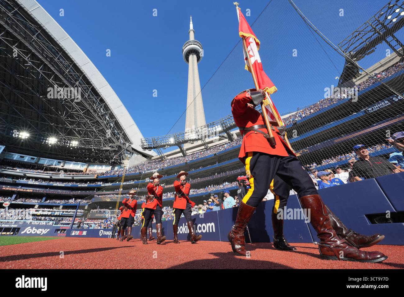 RCMP members carry a Canadian flag before Game 2 of baseball's American ...