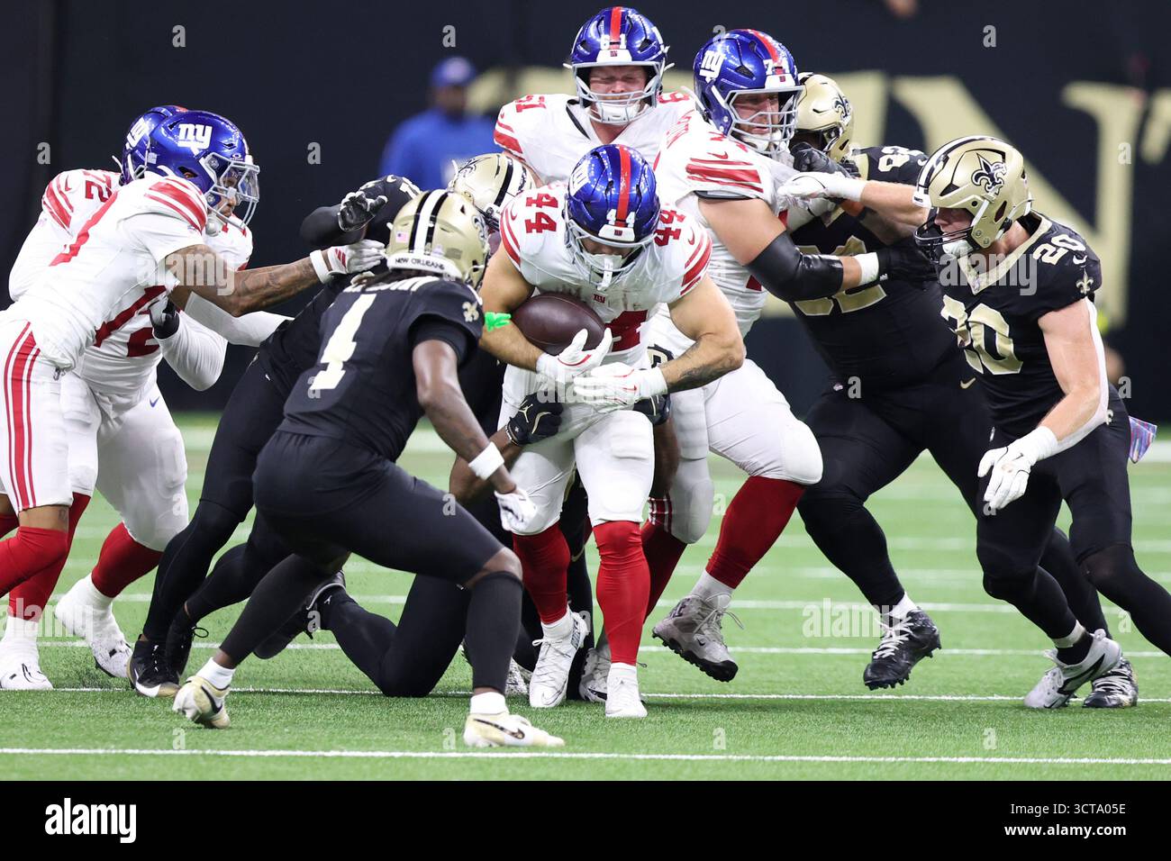 A number of New Orleans Saints defenders try to tackle New York Giants ...