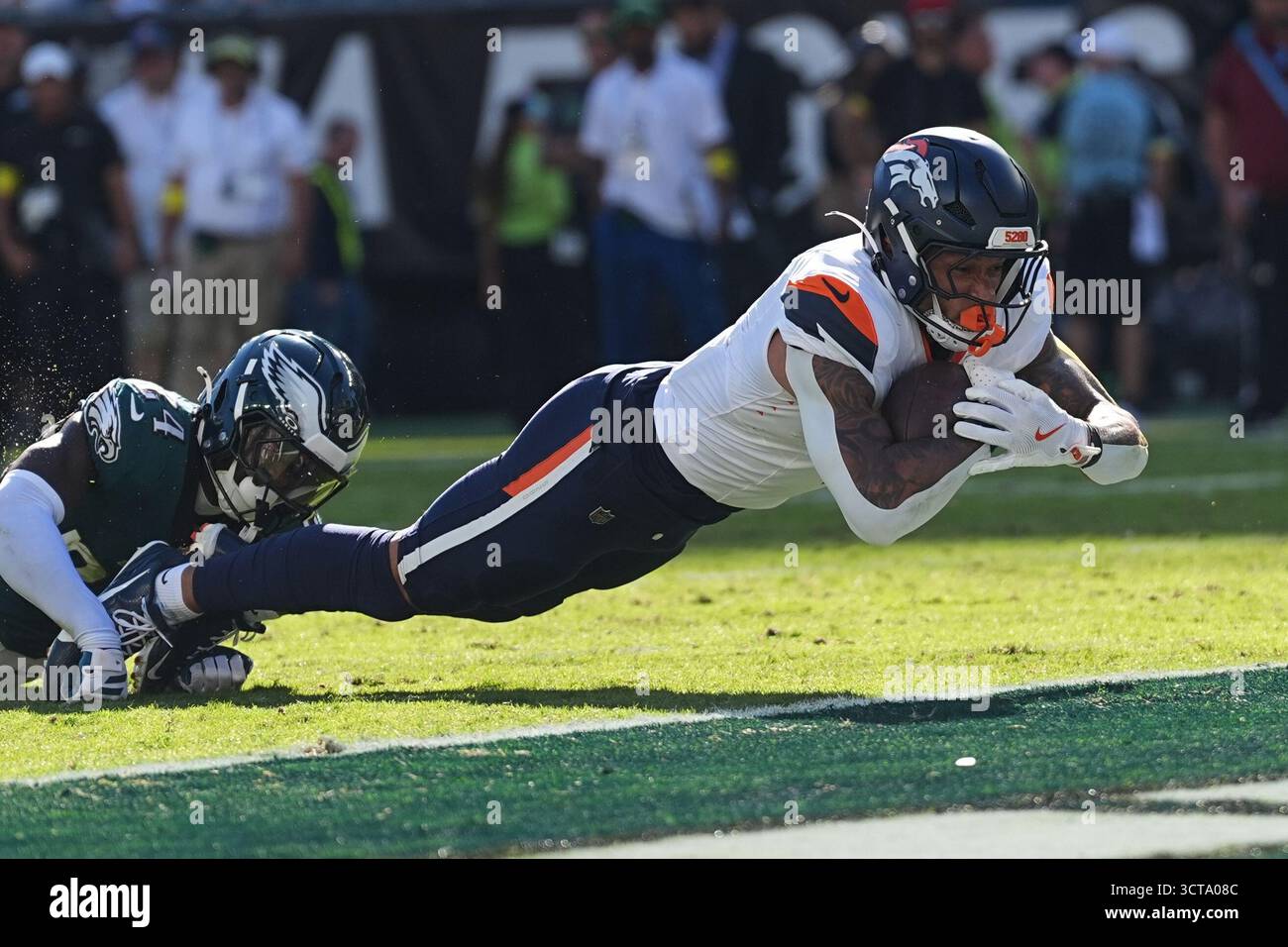 Denver Broncos tight end Evan Engram (1) scores a touchdown in front of ...