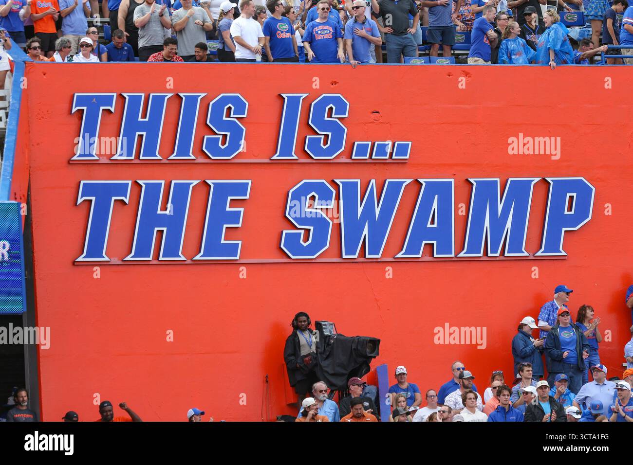"This is ... the Swamp," adorns a stadium wall before an NCAA football ...