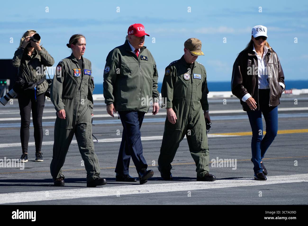 President Donald Trump and first lady Melania Trump walk on the flight ...