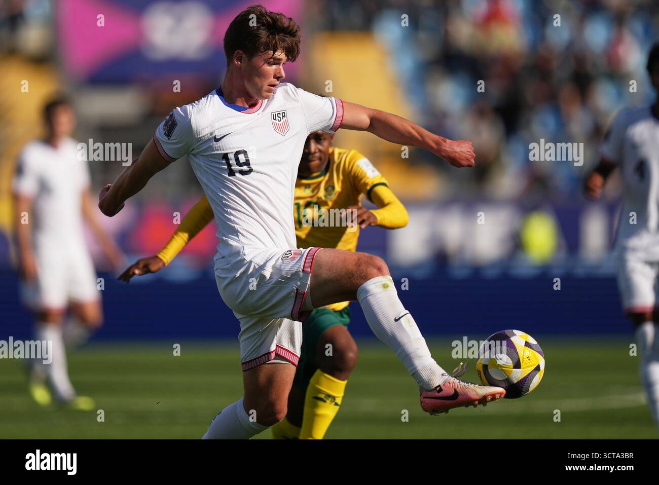 United States' Matthew Corcoran controls the ball past South Africa's ...