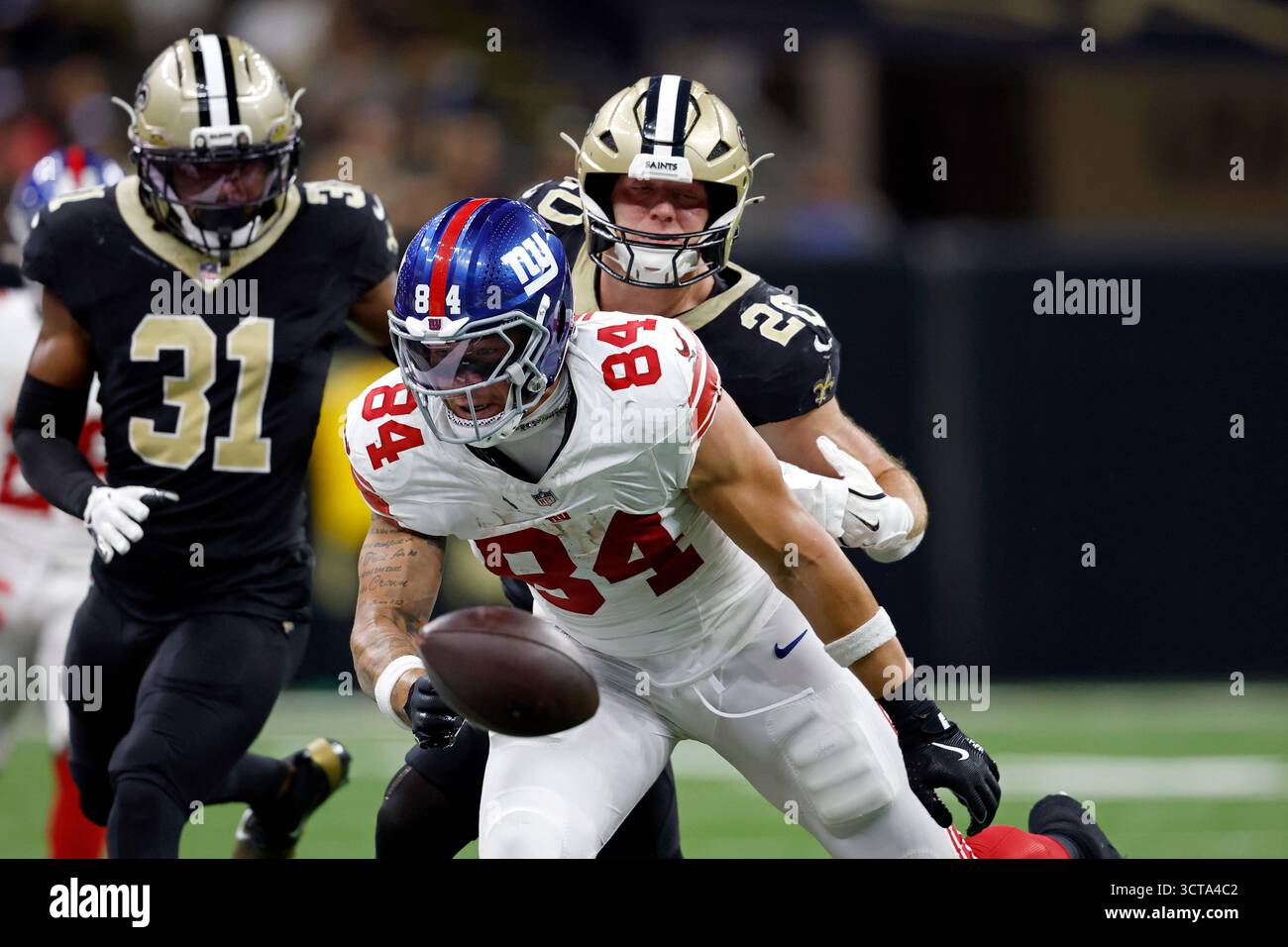 New York Giants tight end Theo Johnson (84) attempts to catch the ball ...