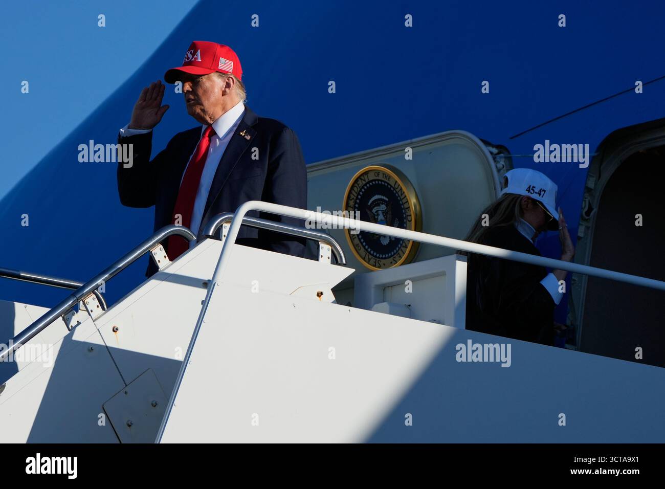 President Donald Trump salutes as he boards Air Force One with first ...