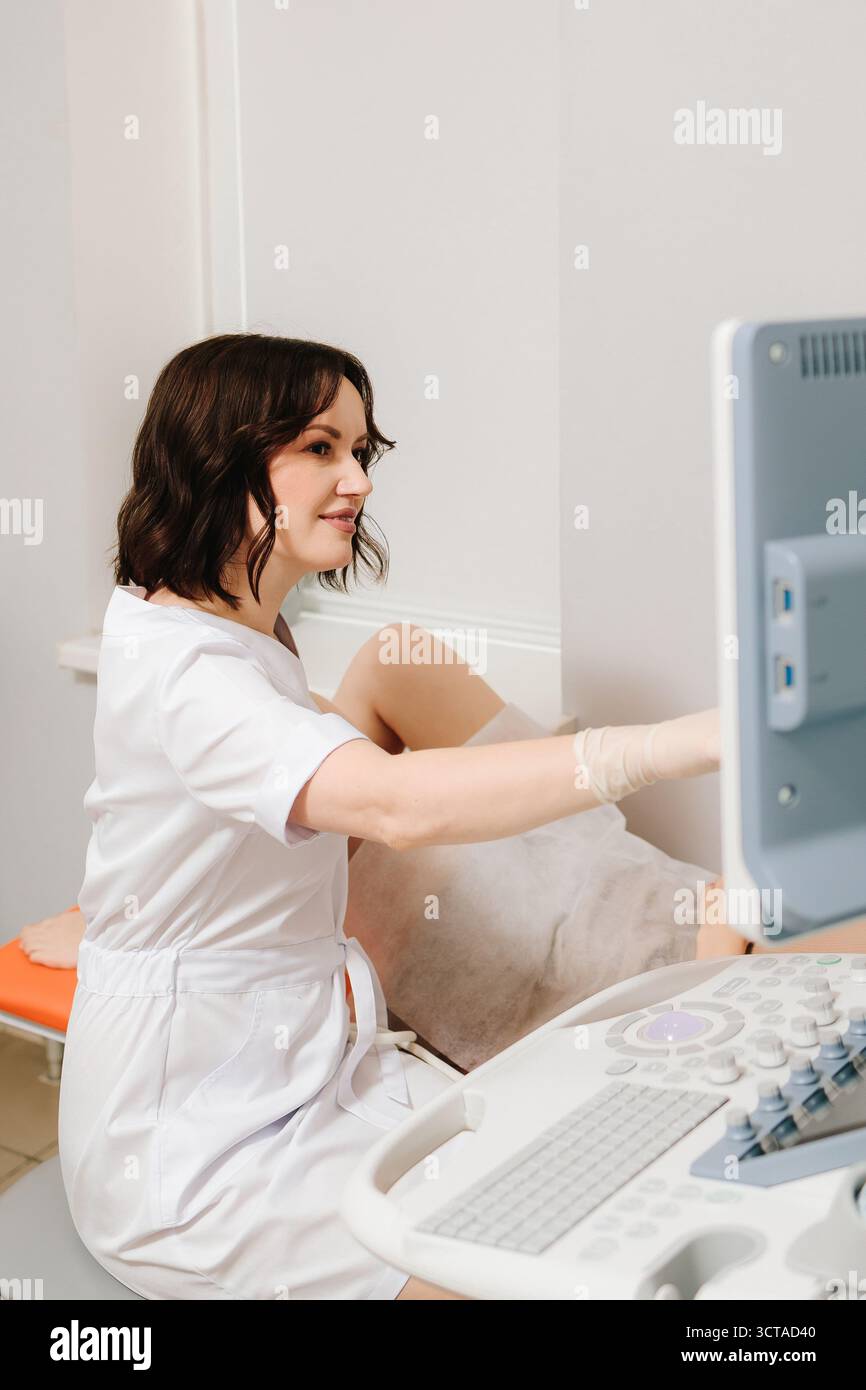 Gynecologist and patient reviewing ultrasound scan results together on ...