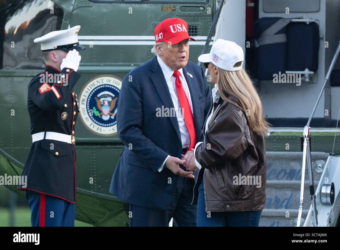 President Donald Trump talks to first lady Melania Trump as they ...