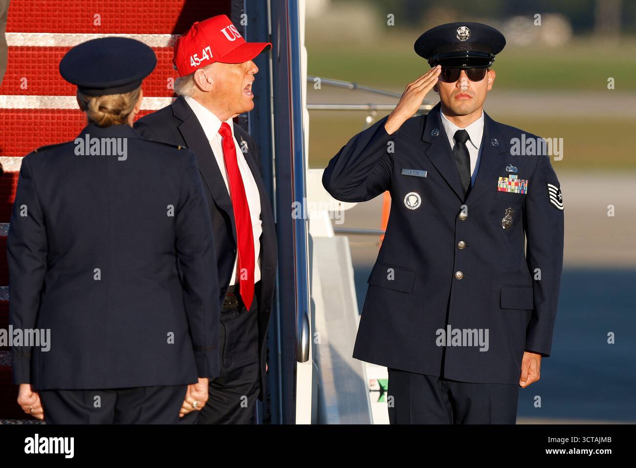 President Donald Trump, center, is greeted by Air Force 89th Air Wing ...