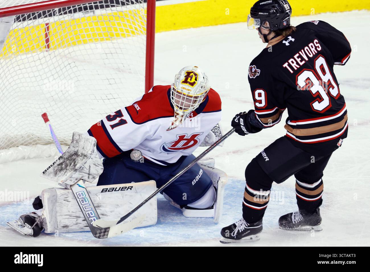 Lethbridge Hurricanes goalie Leif Oaten, lt, makes a save against ...