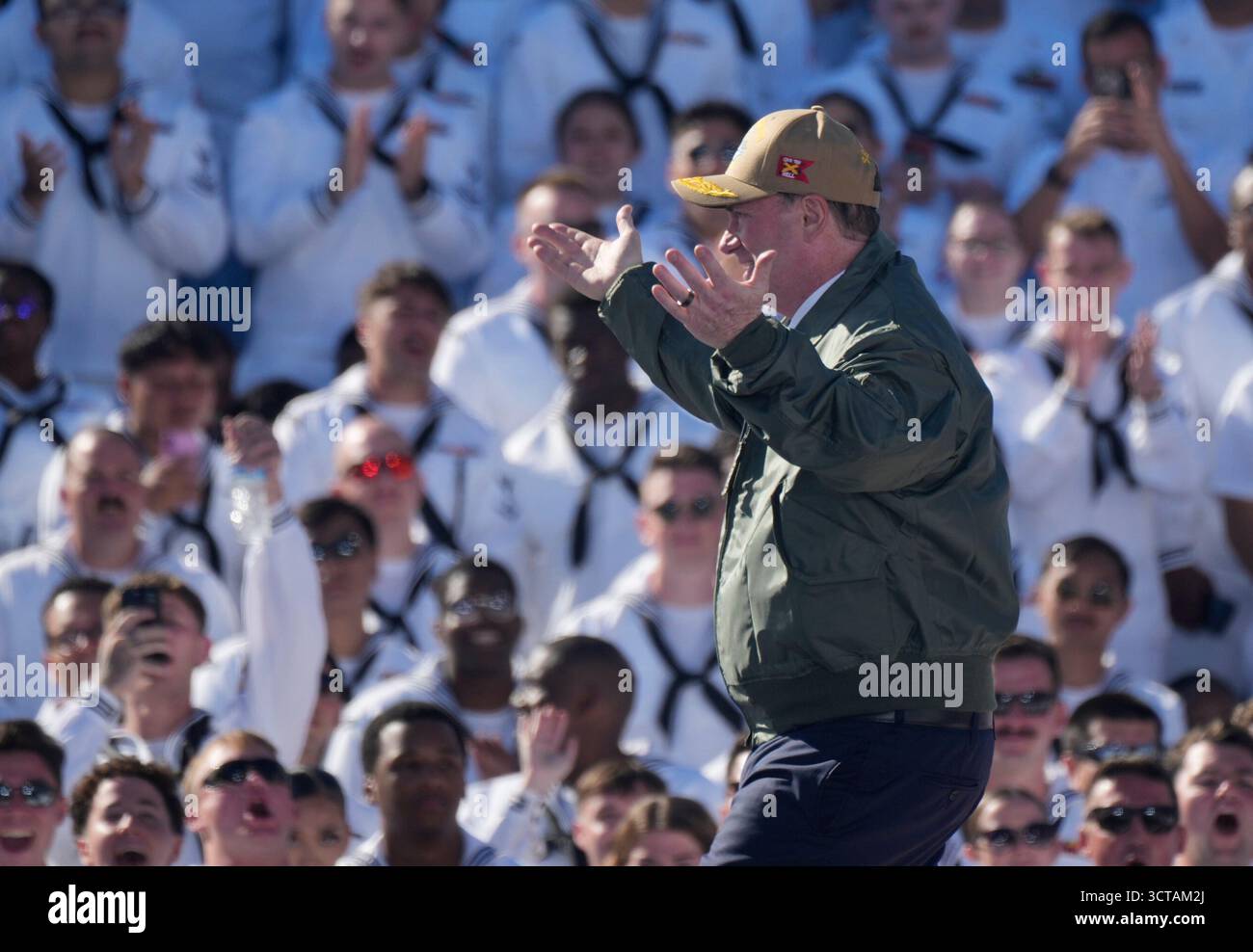 Secretary of the Navy John Phelan waves to the crowd as he walks down ...