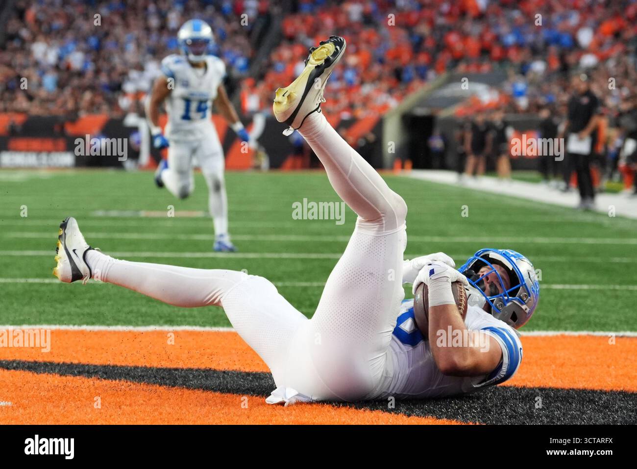Detroit Lions wide receiver Isaac TeSlaa, right, falls in the end zone ...