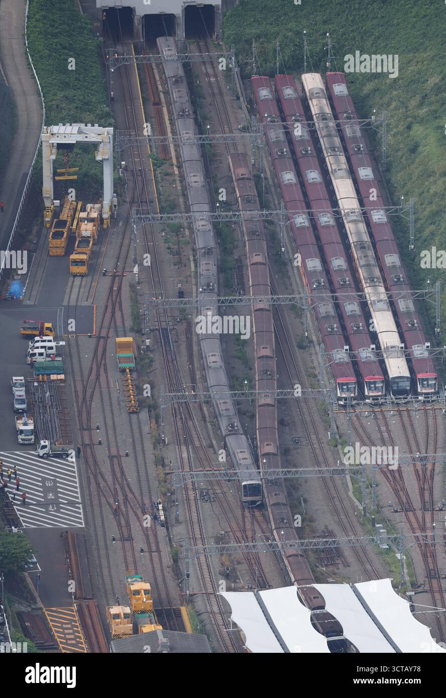 An aerial photo shows the accident scene of the collision and derailed site at Kajigaya Station ...