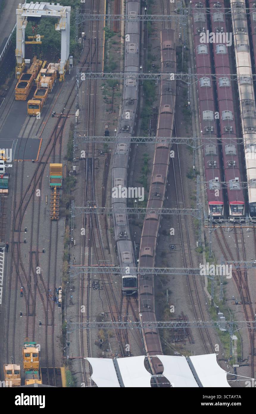 An aerial photo shows the accident scene of the collision and derailed site at Kajigaya Station ...