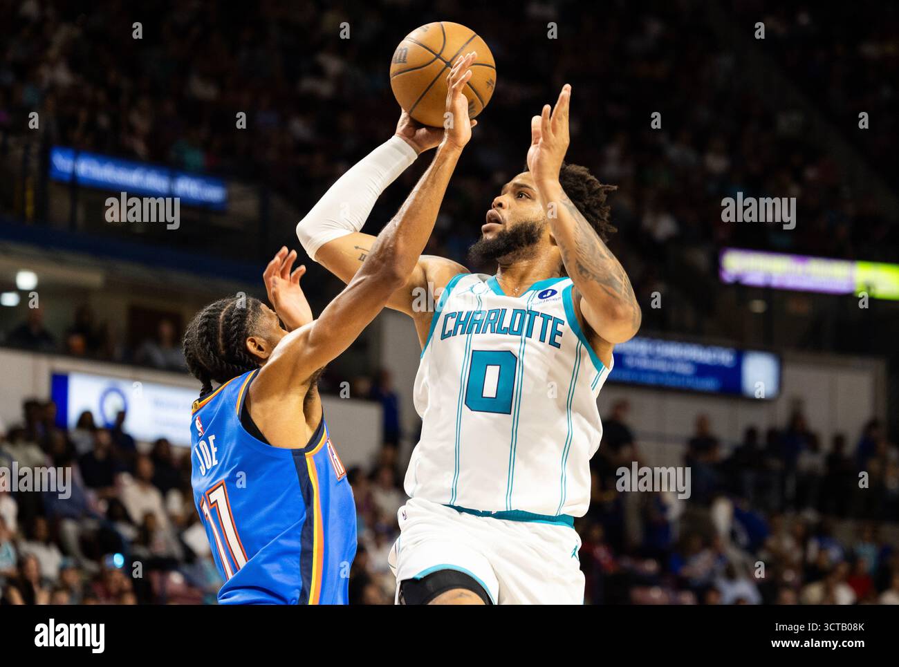Charlotte Hornets forward Miles Bridges, right, shoots against Oklahoma City Thunder guard ...