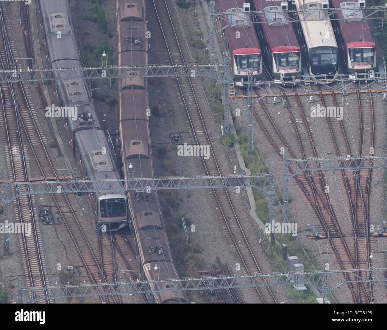 An aerial photo shows the accident scene of the collision and derailed site at Kajigaya Station ...