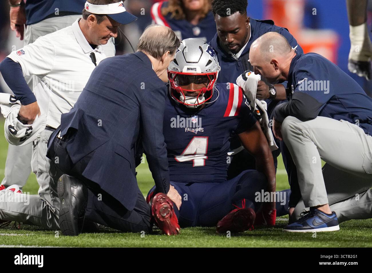 New England Patriots running back Antonio Gibson (4) is attended to ...