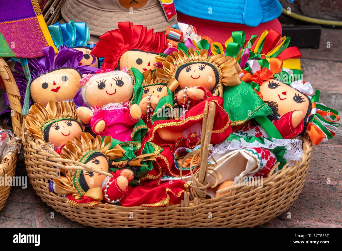 A basket filled with a variety of dolls, each with unique colors and ...