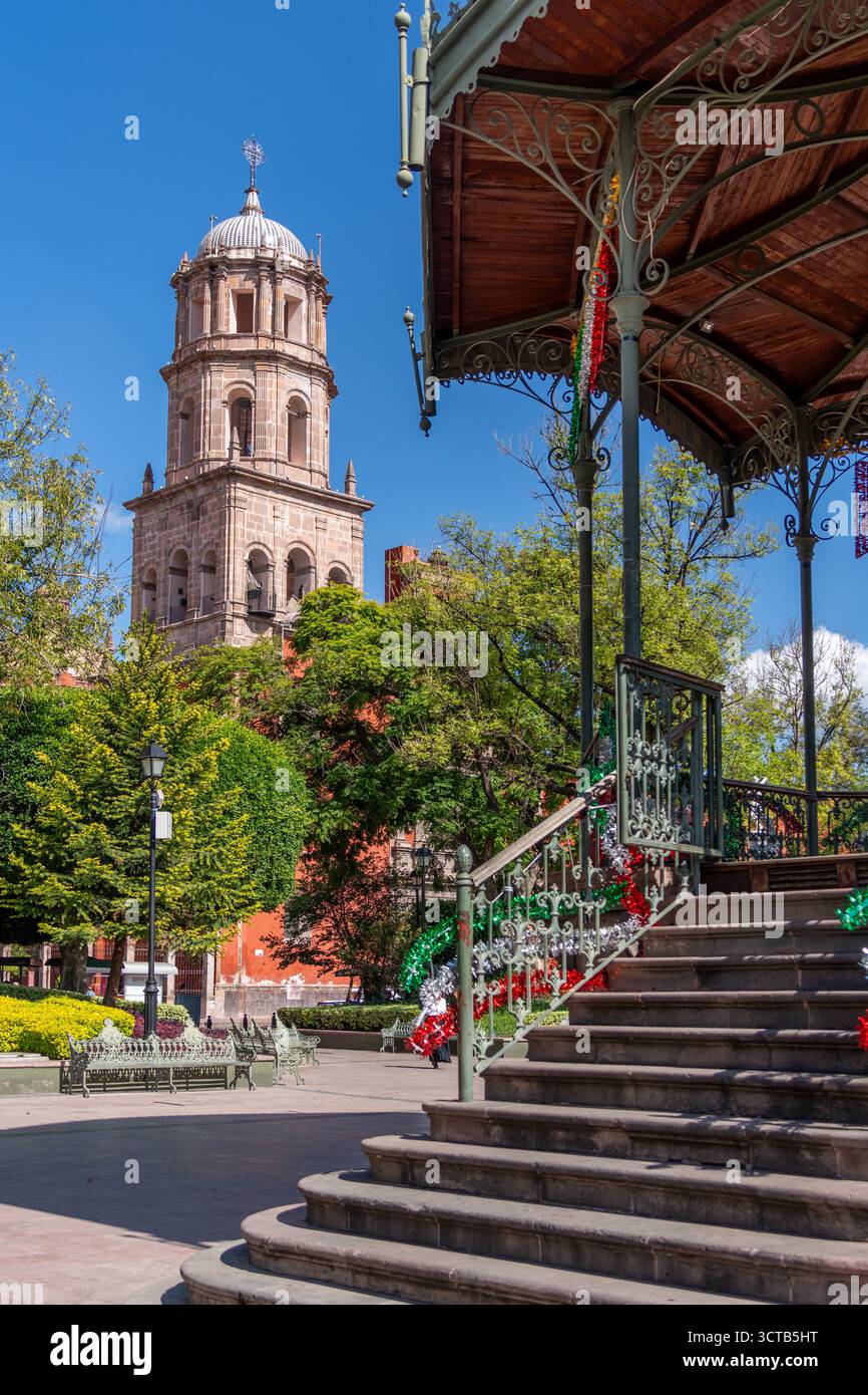 A green and red staircase leads to a balcony. The balcony is under a ...