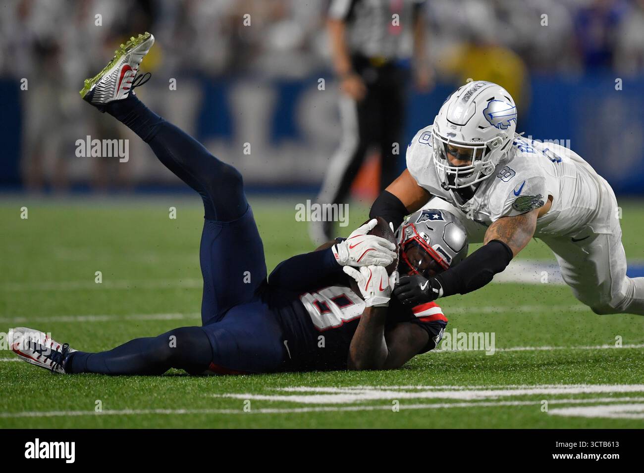 New England Patriots wide receiver Stefon Diggs, left, is hit by ...
