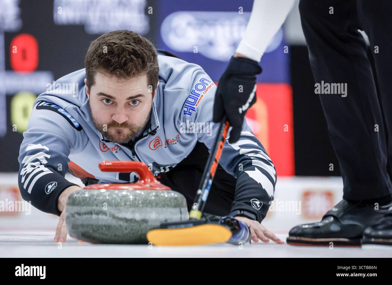 Team Dunstone skip Matt Dunstone makes a shot against Team Jacobs ...