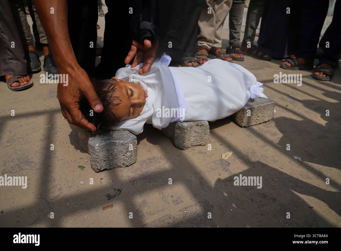 The body of 5-year-old Jamal al-Najjar is placed on a pedestal of ...