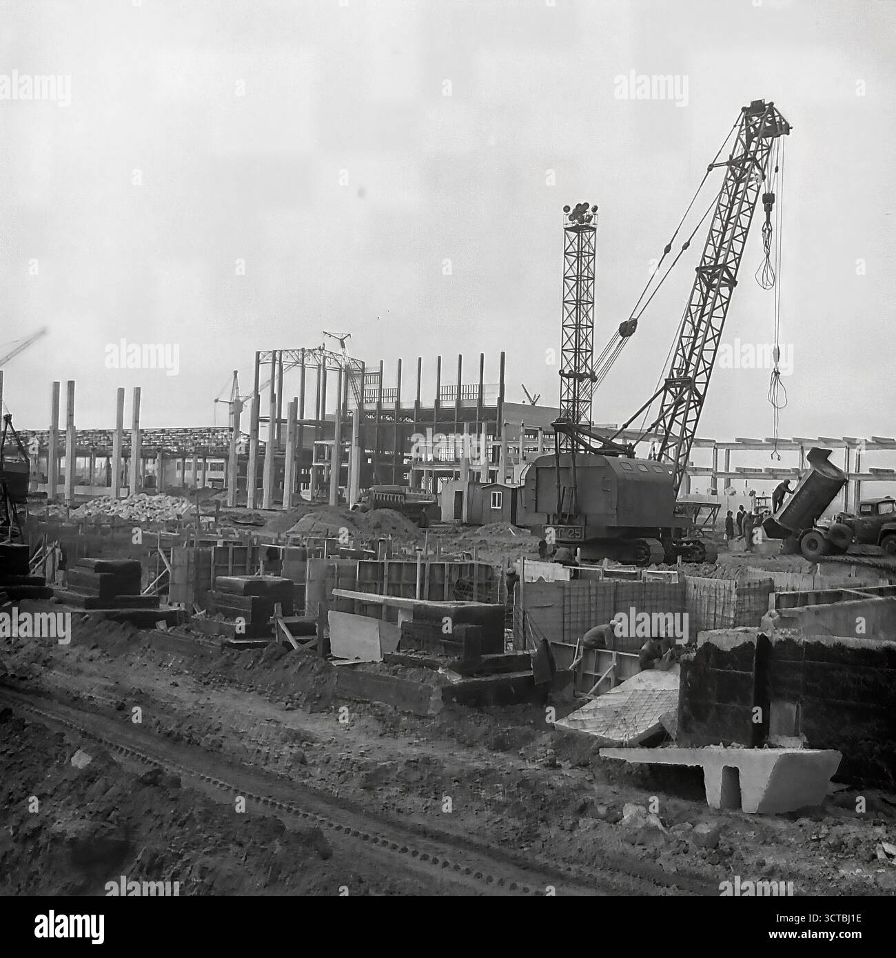 A panoramic view of a massive industrial construction site in 1960s ...