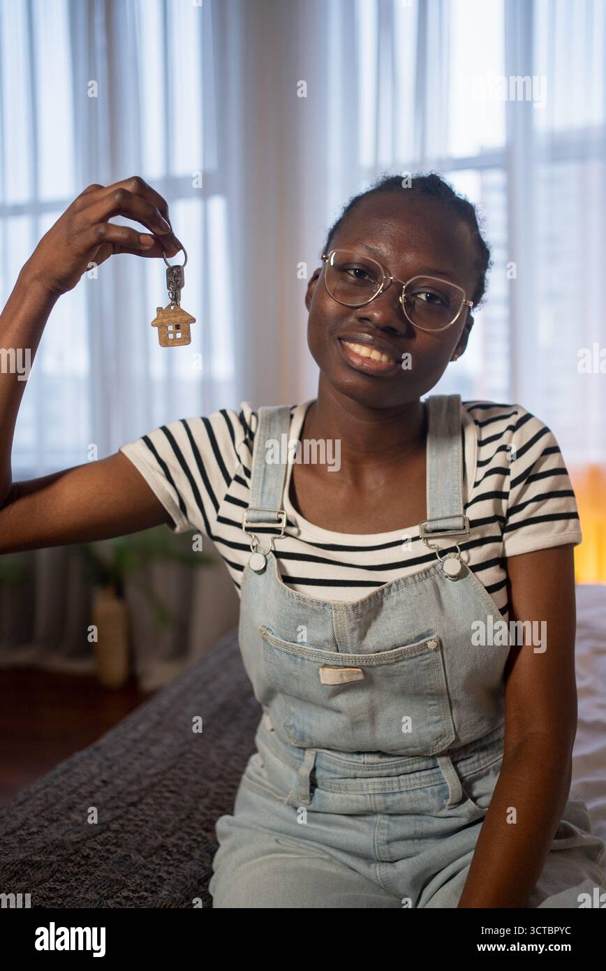 Happy homeowner smiling and showing keys to her new apartment ...