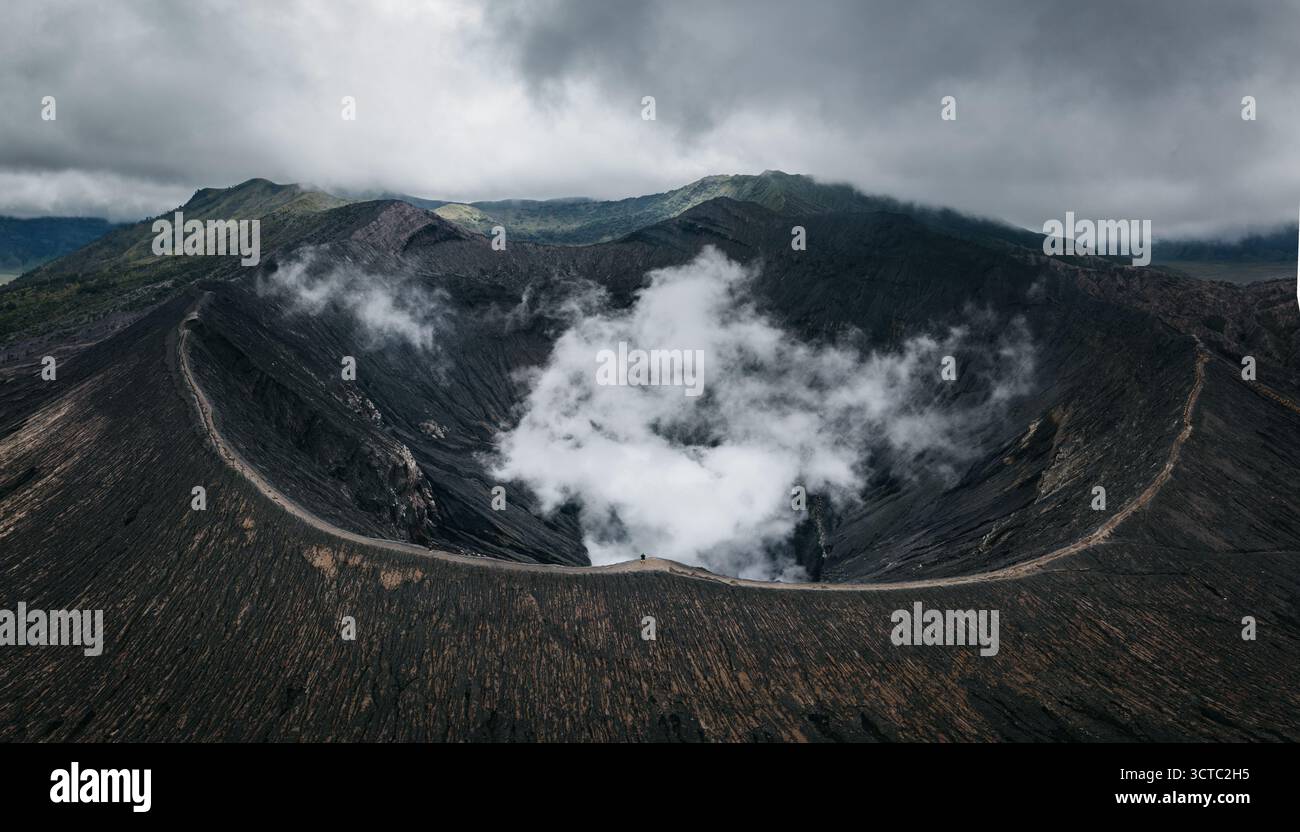 Aerial view of the Bromo volcano crater, a dark, textured landscape ...