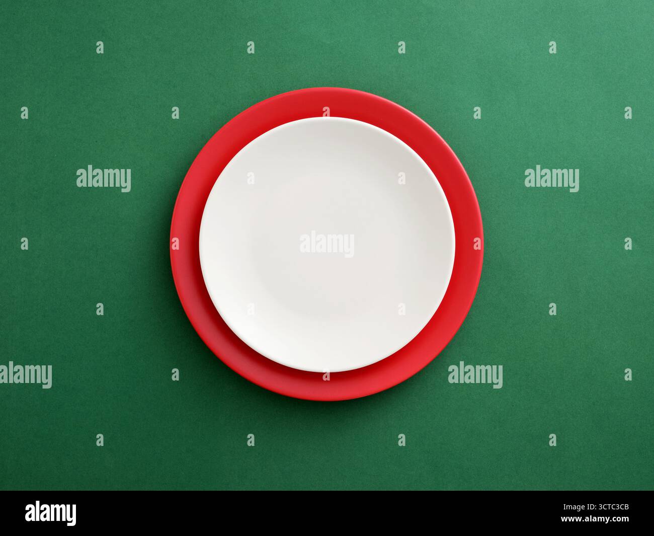 Stacked red and white plates creating festive red, white, and green ...